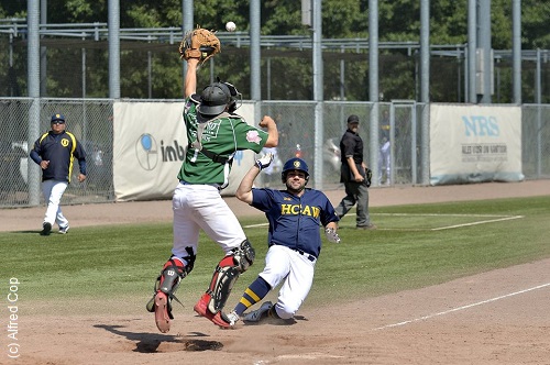 Kevin Dirksen slides past catcher Levine Gabriëls to score for HCAW ...